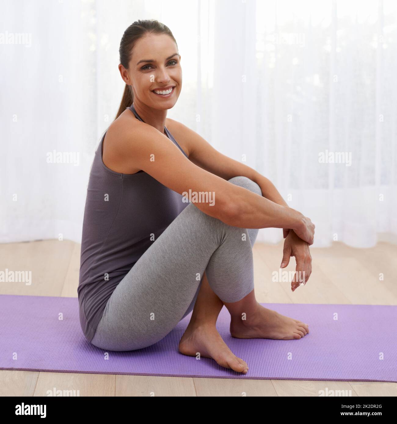 Feelling invigorated after yoga. A beautiful young woman taking a break ...