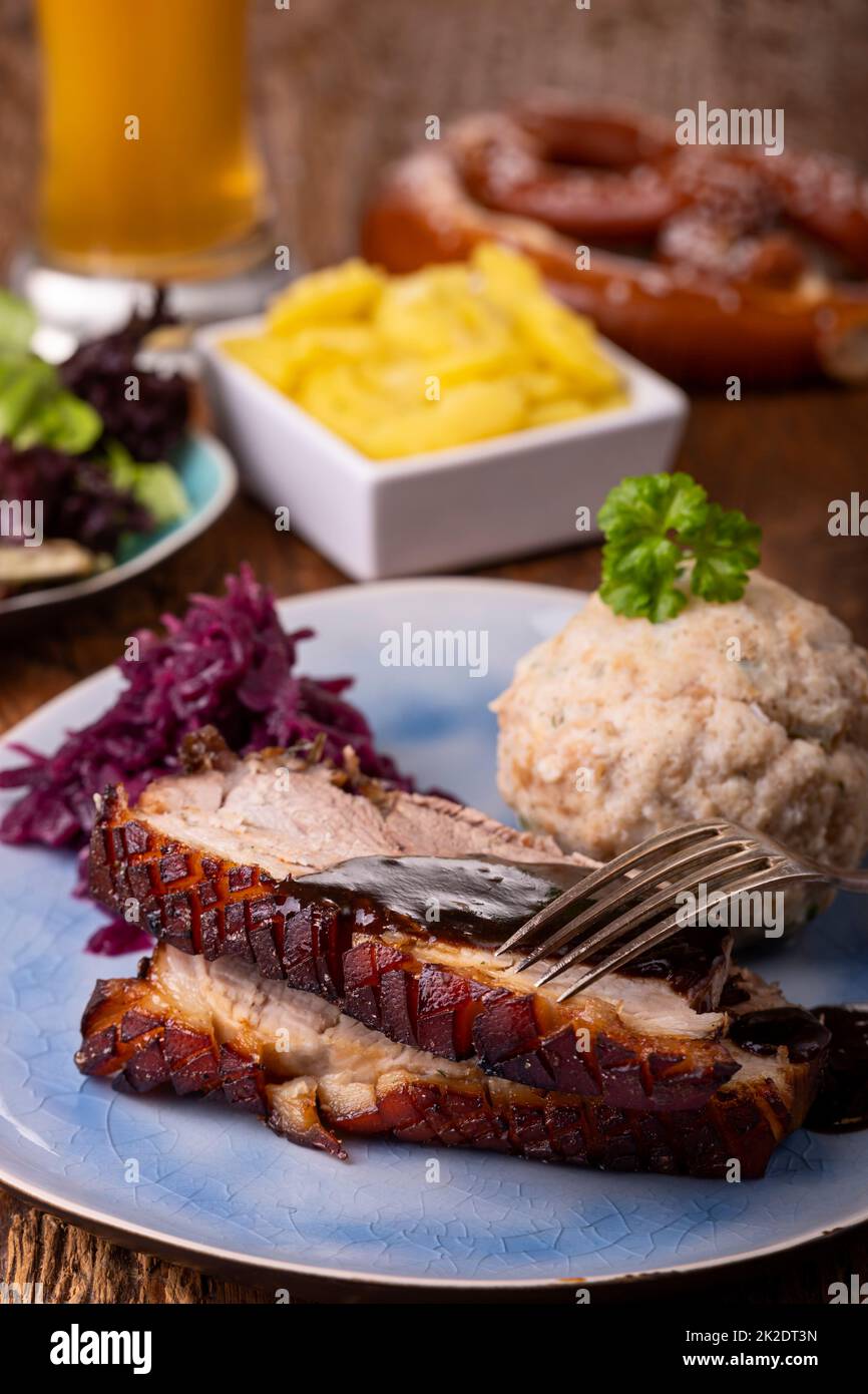 portion of fresh roasted pork on a blue plate Stock Photo - Alamy