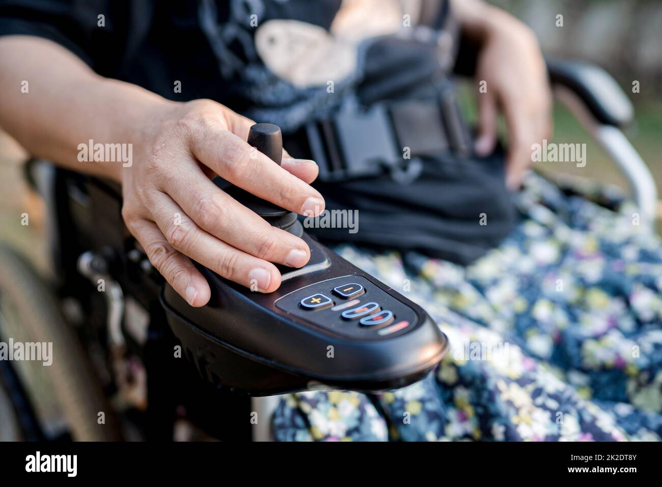 Asian lady woman patient on electric wheelchair with joystick and ...