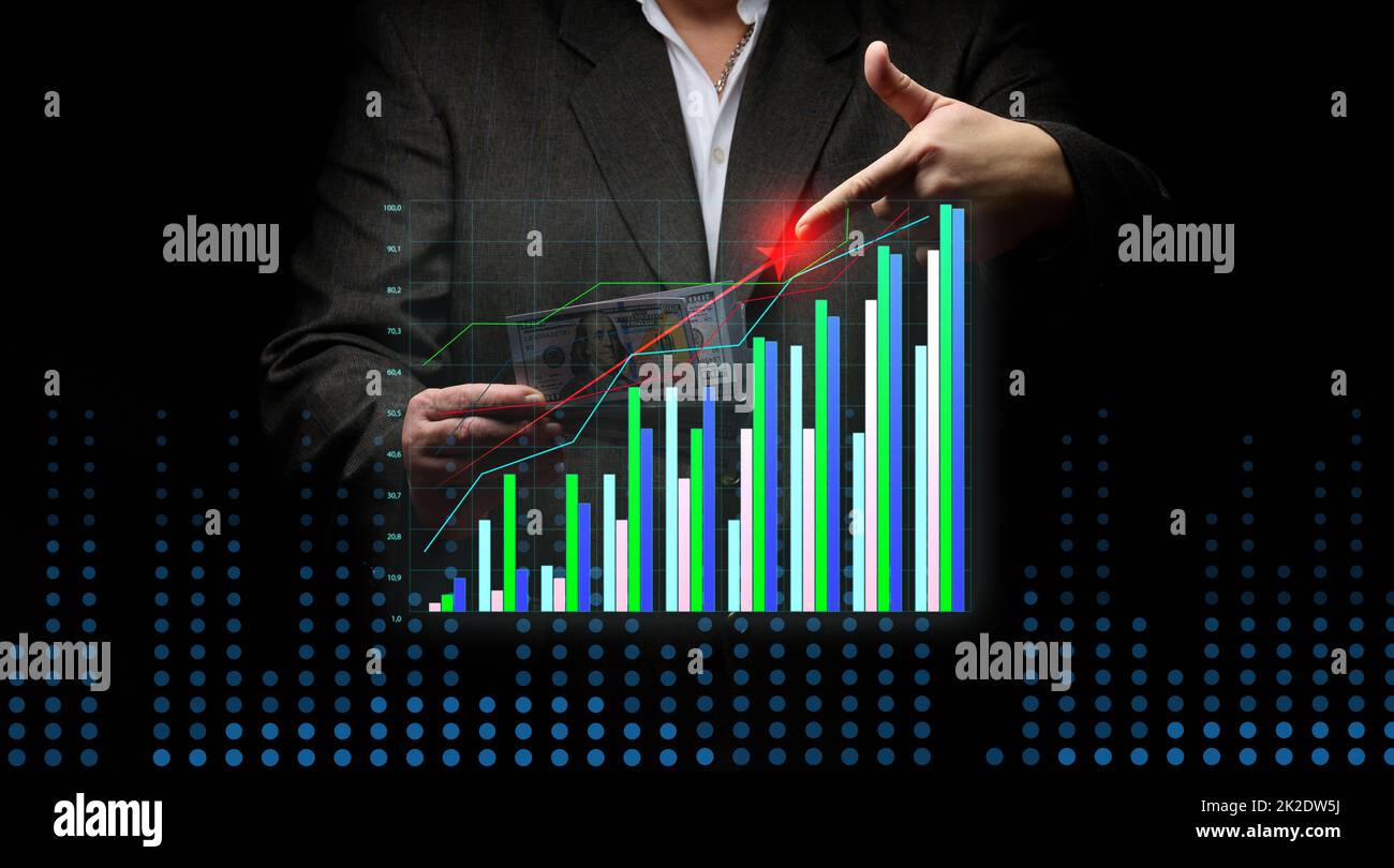 businessman in a suit holds a pack of paper american dollars against ...