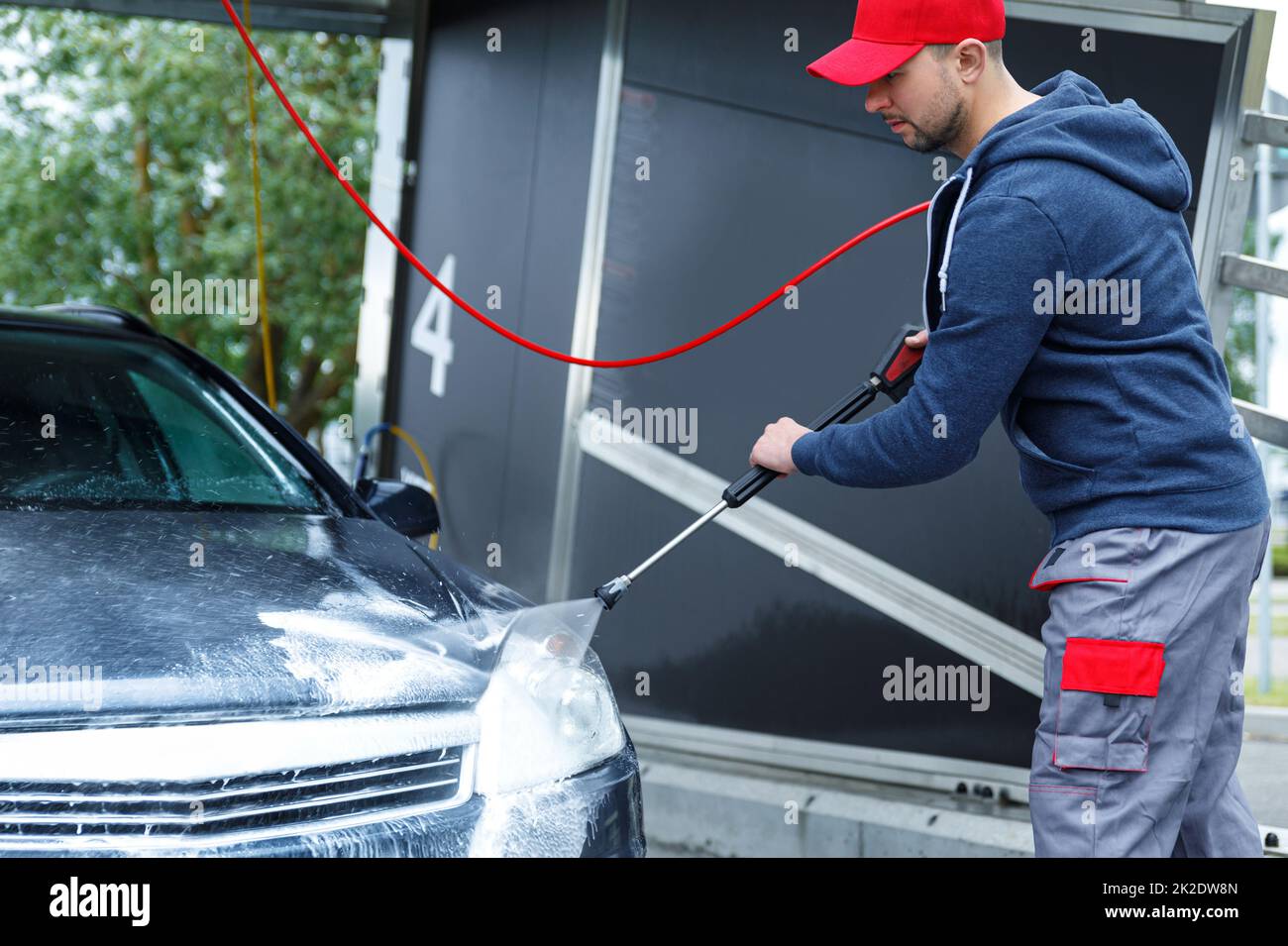 Car wash worker is washing client's car Stock Photo - Alamy