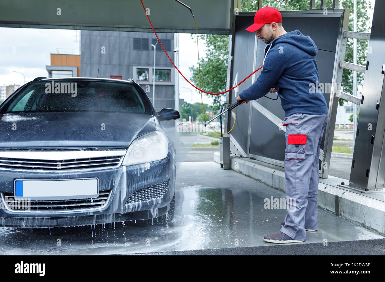 Car wash worker is washing client's car Stock Photo - Alamy