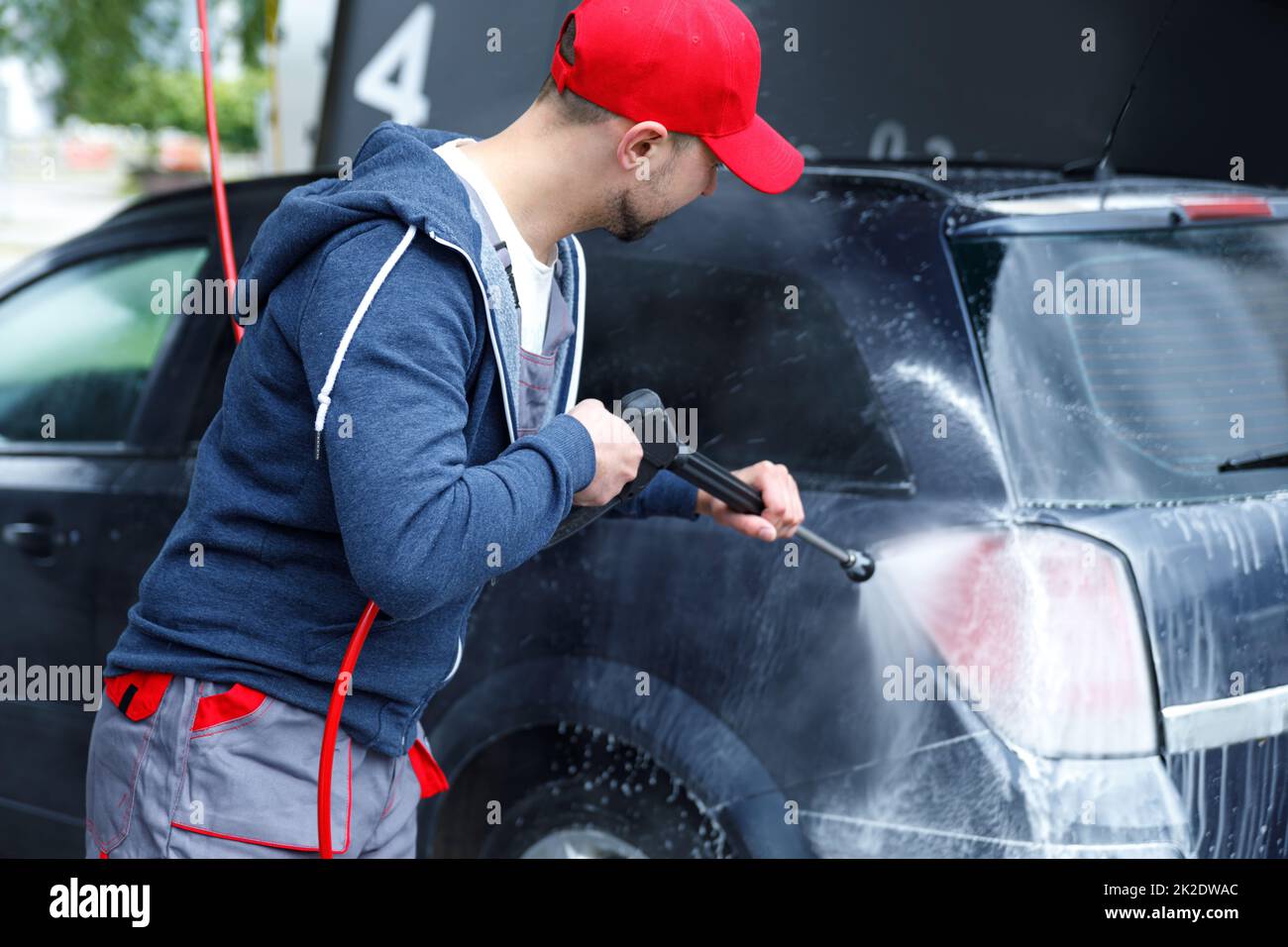 Car wash worker is washing client's car Stock Photo - Alamy