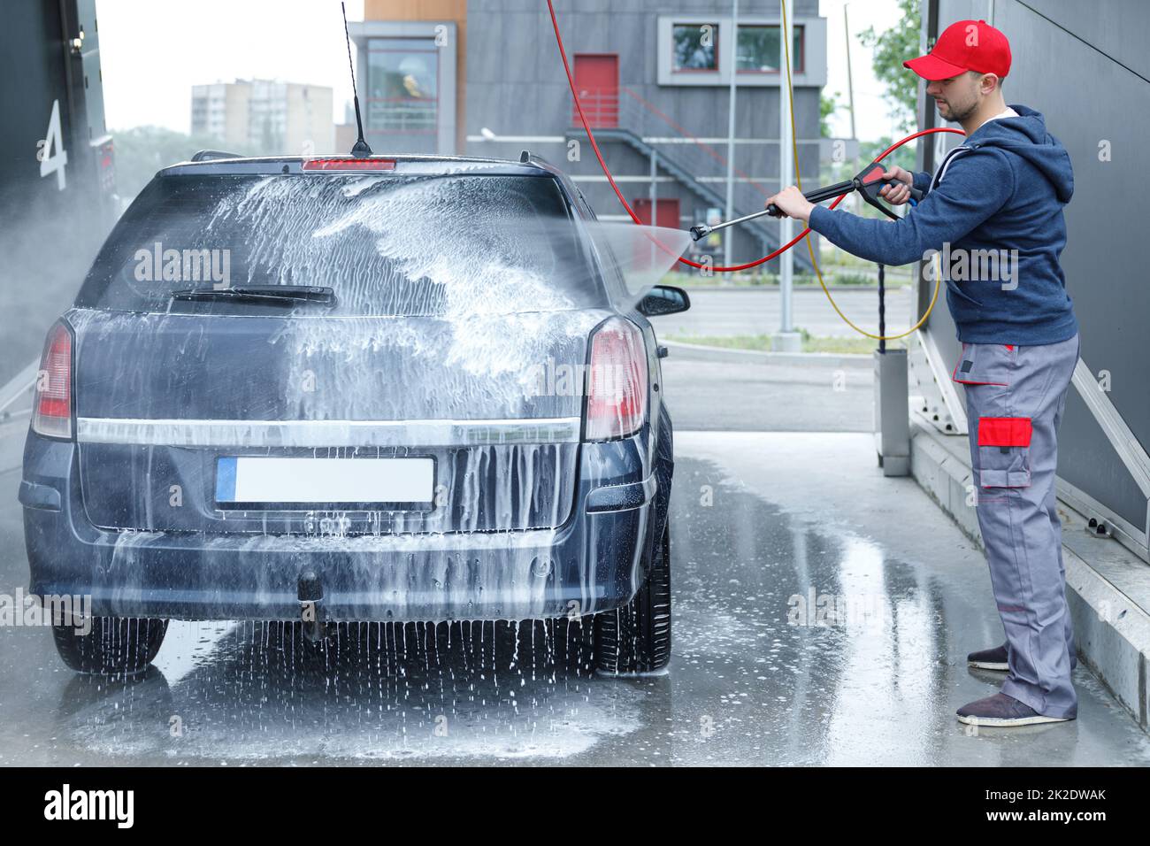 Car wash worker is washing client's car Stock Photo - Alamy