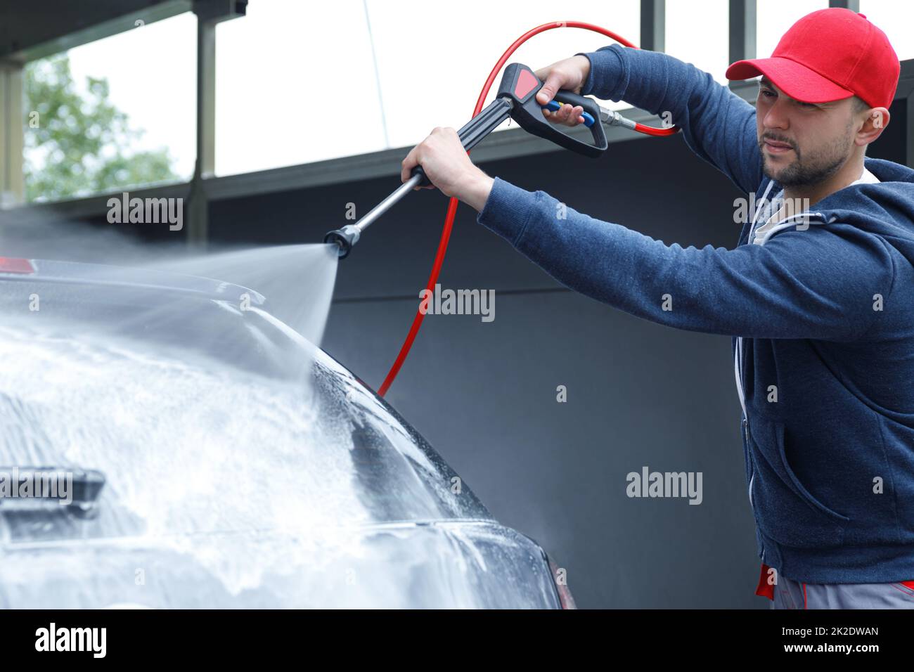 Car wash worker is washing client's car Stock Photo - Alamy