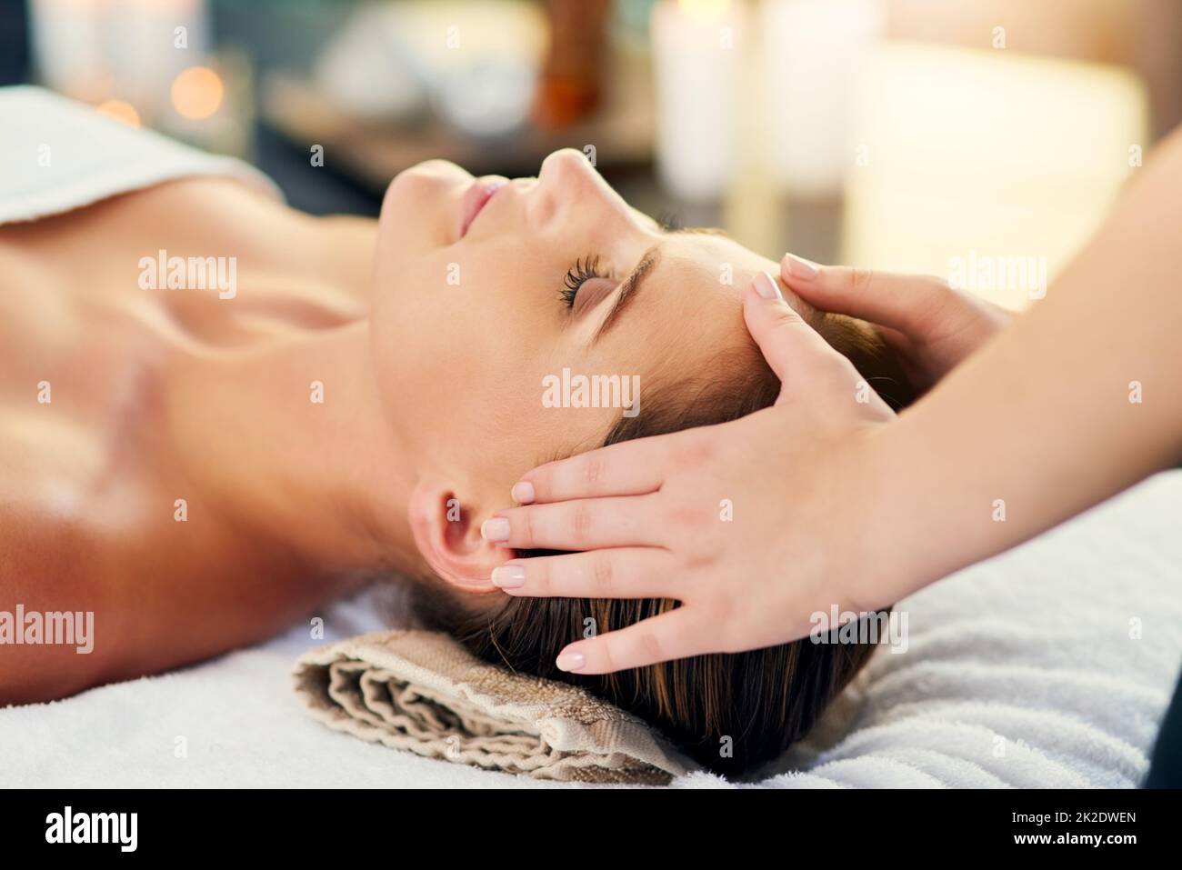 I deserve every minute of it. Shot of a beautiful young woman lying on ...