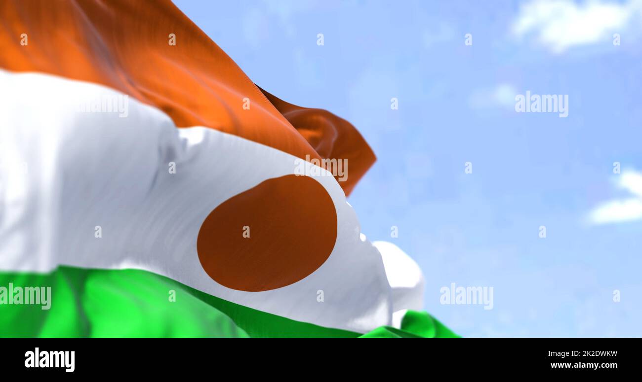 Detail of the national flag of Niger waving in the wind on a clear day ...
