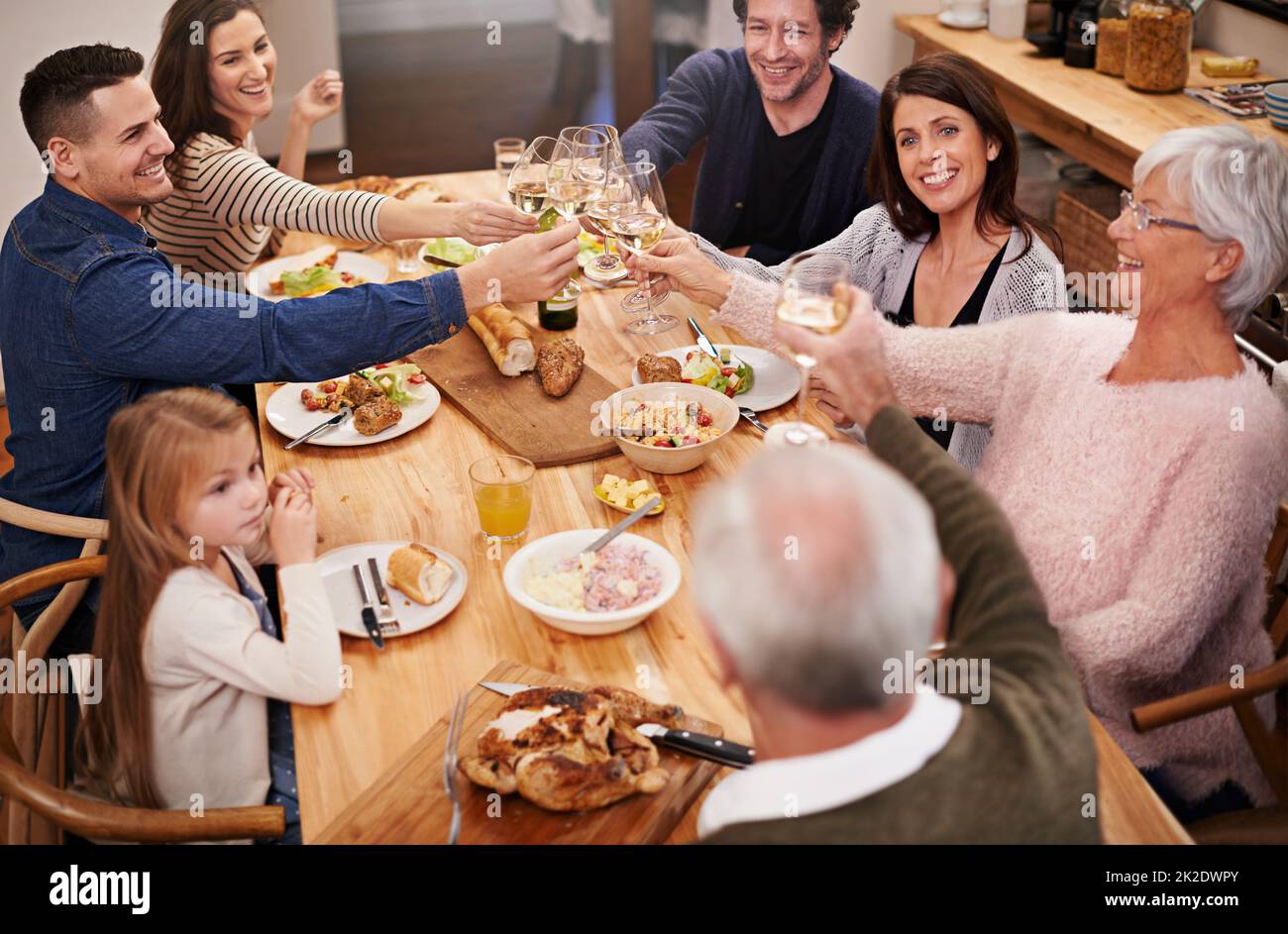 Toasting to family. Cropped shot of a family sitting down to dinner ...
