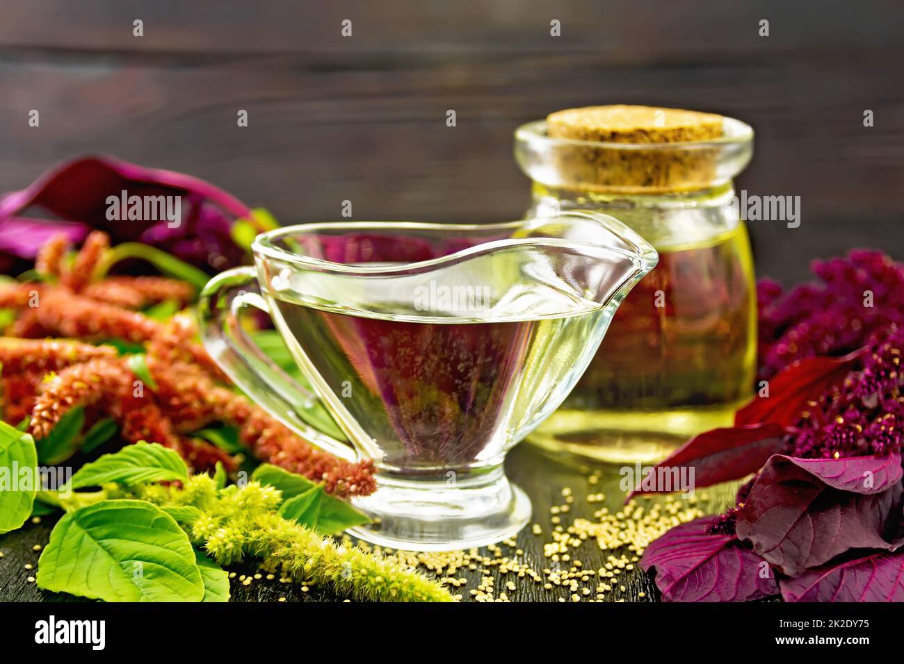 Oil amaranth in gravy boat on dark board Stock Photo - Alamy