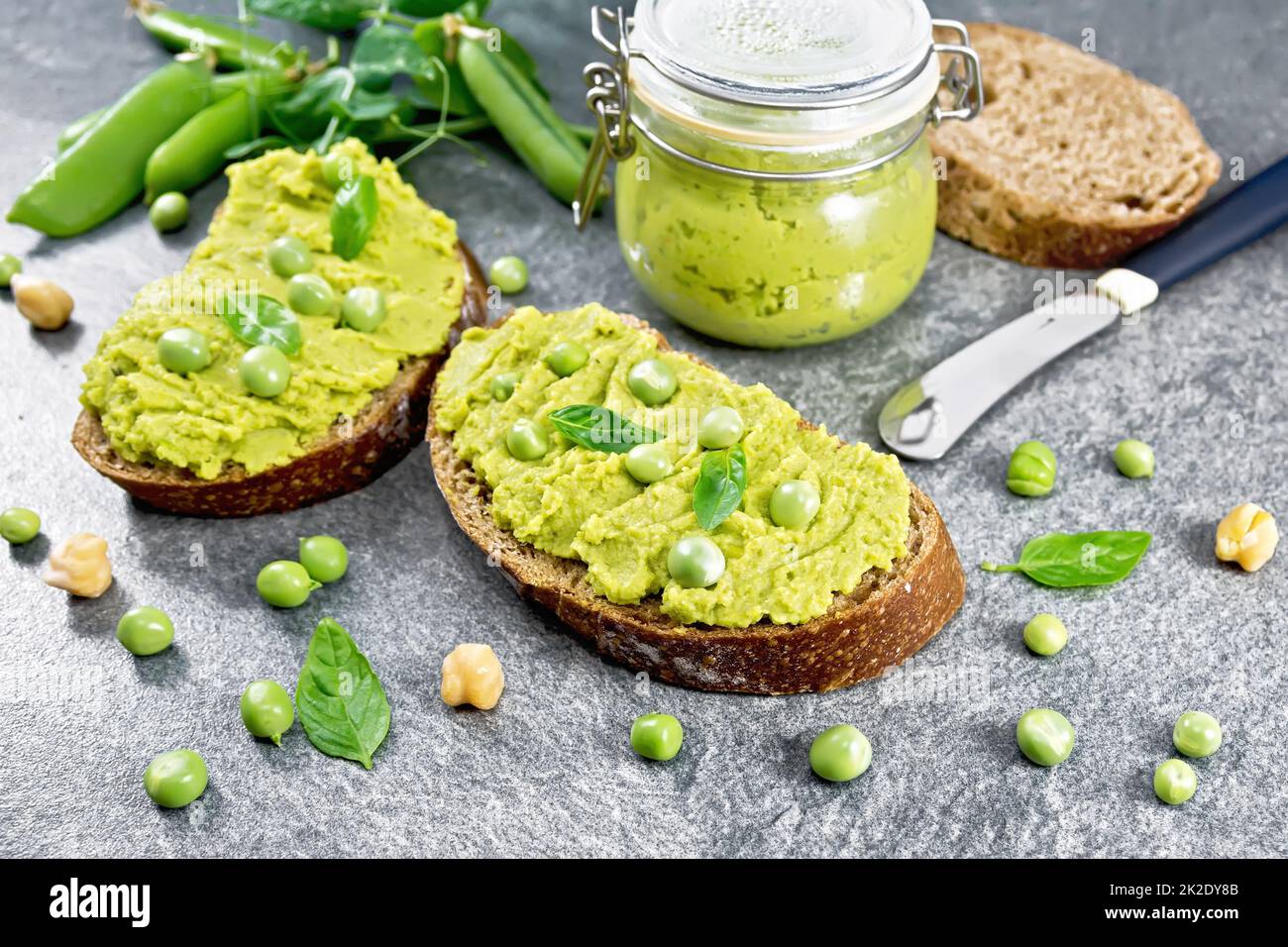 Sandwich green pea hummus on stone dark table Stock Photo - Alamy