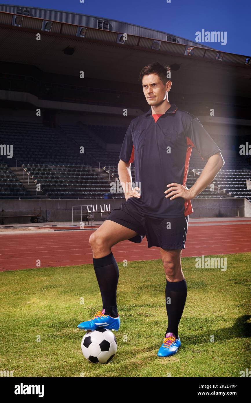 Setting up the free kick. a young footballer standing on a field with a ...
