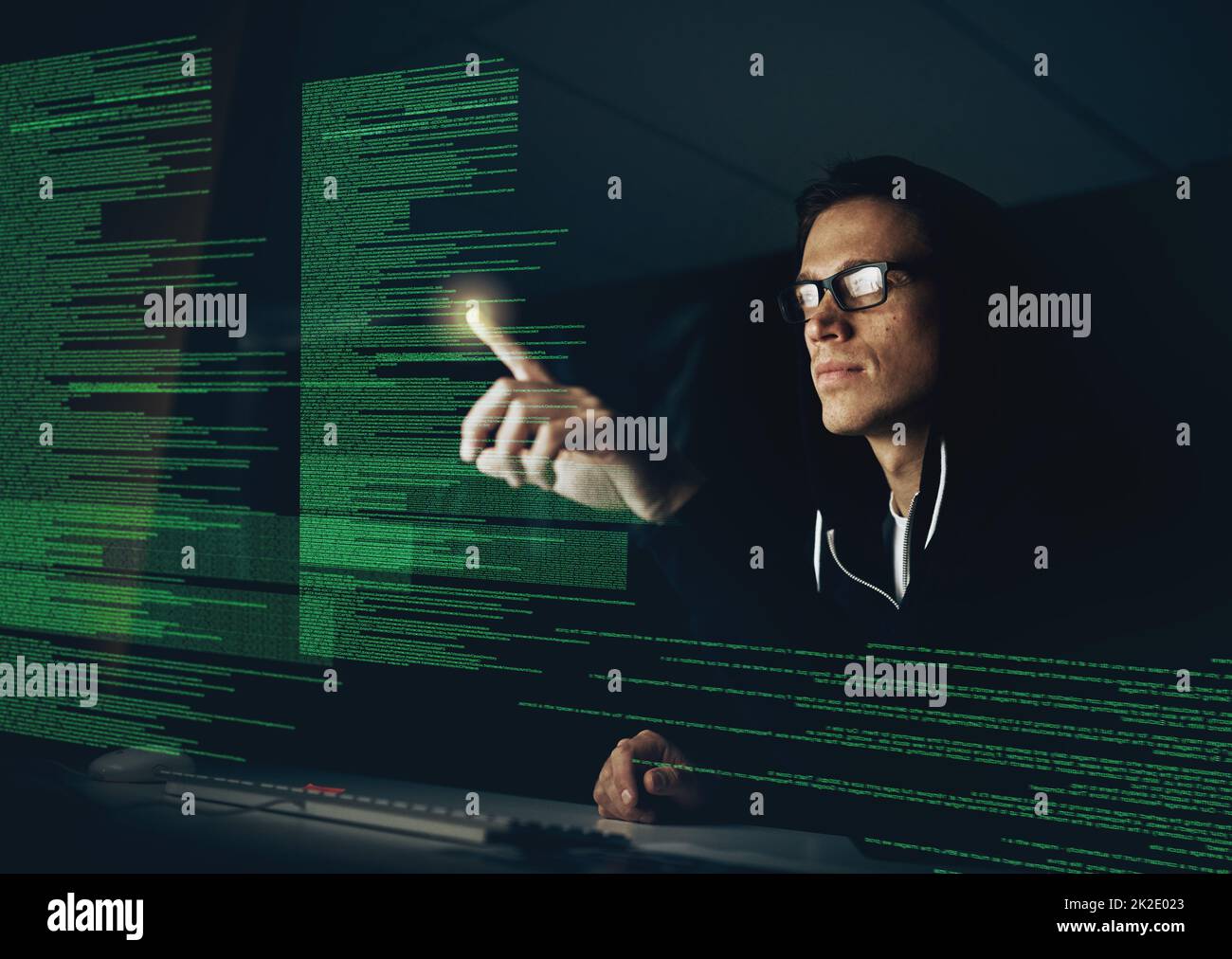 Hacking your system one touch at a time. Cropped shot of a young hacker ...