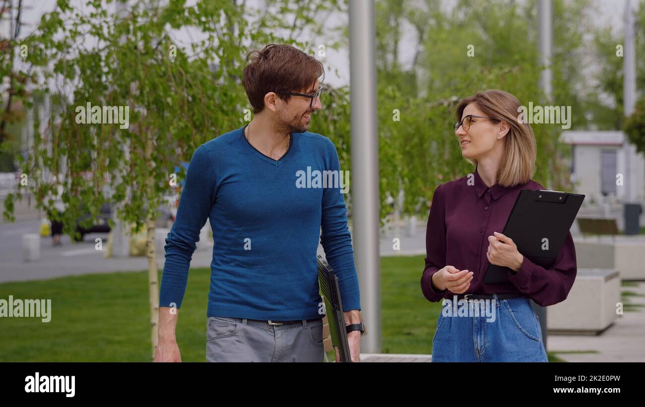 Business Man and Woman talking or Conversation Outdoor in City as ...