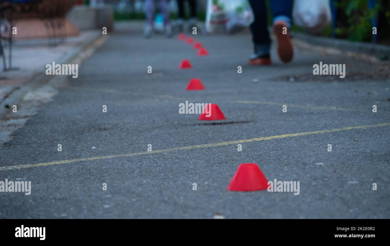 Children skates on asphalt and goes round cones Stock Photo - Alamy