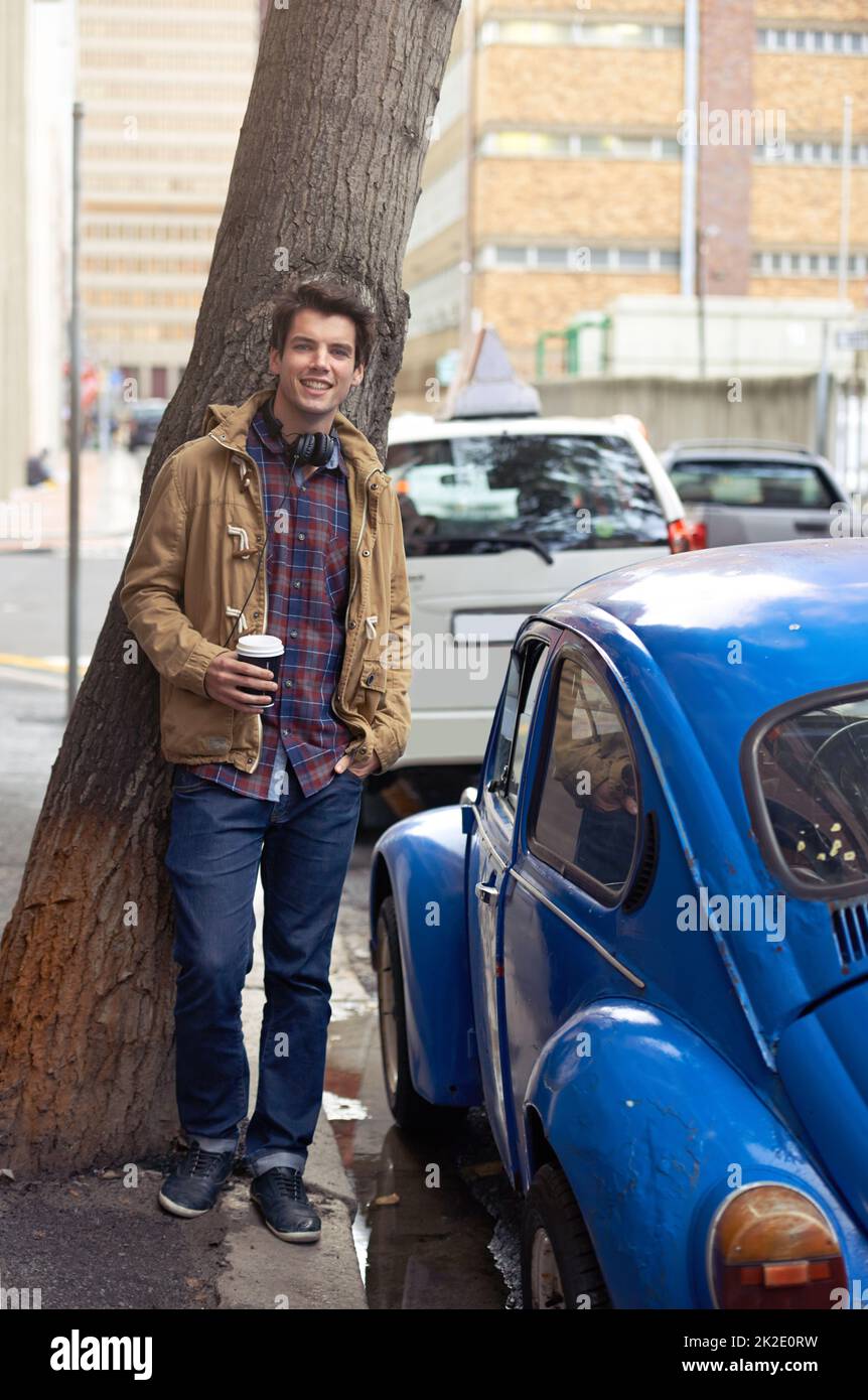 Out and about, around downtown. a handsome young man chilling in a ...