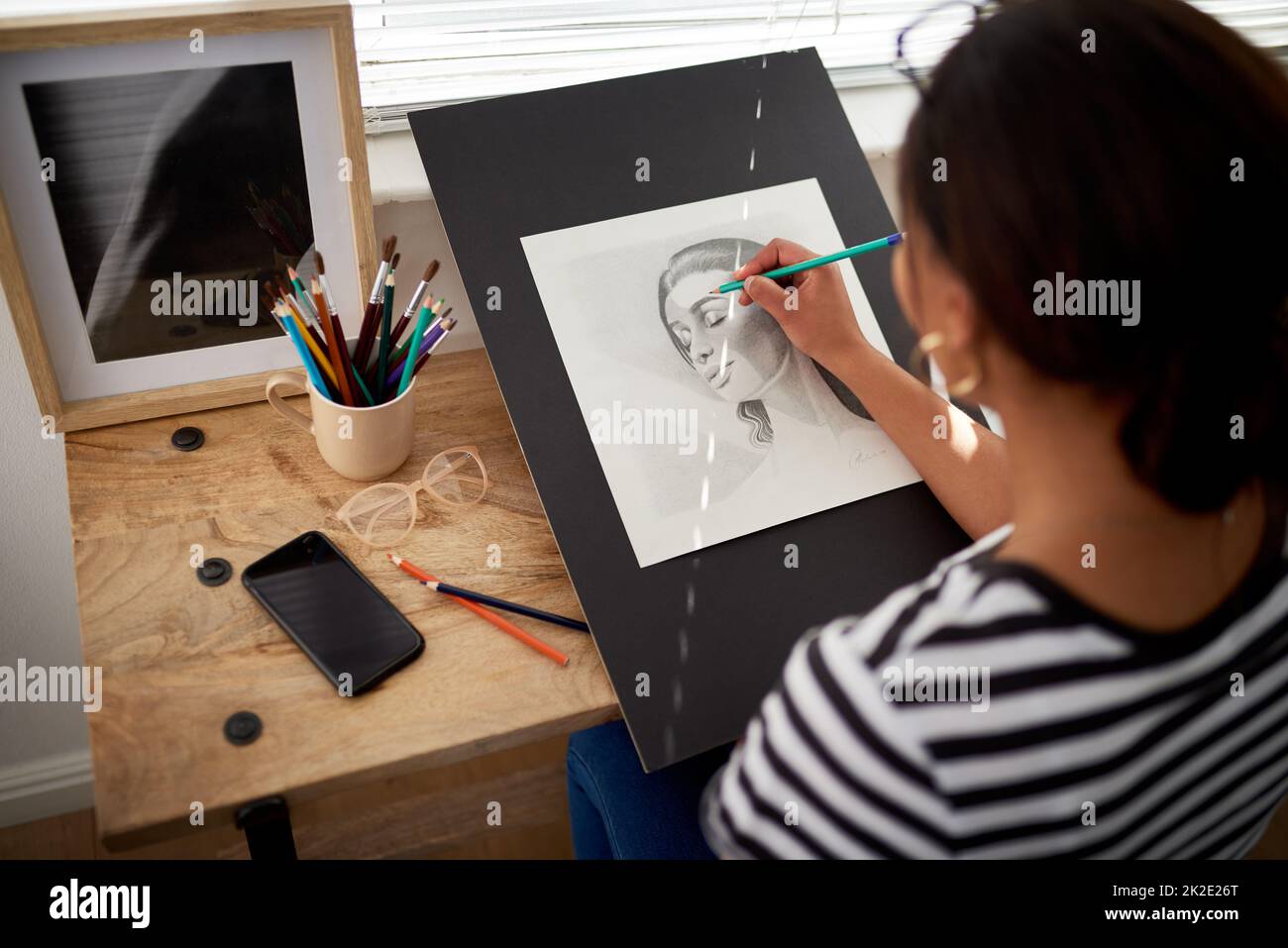 Every push of the pencil tells a story. Rearview of shot of an ...