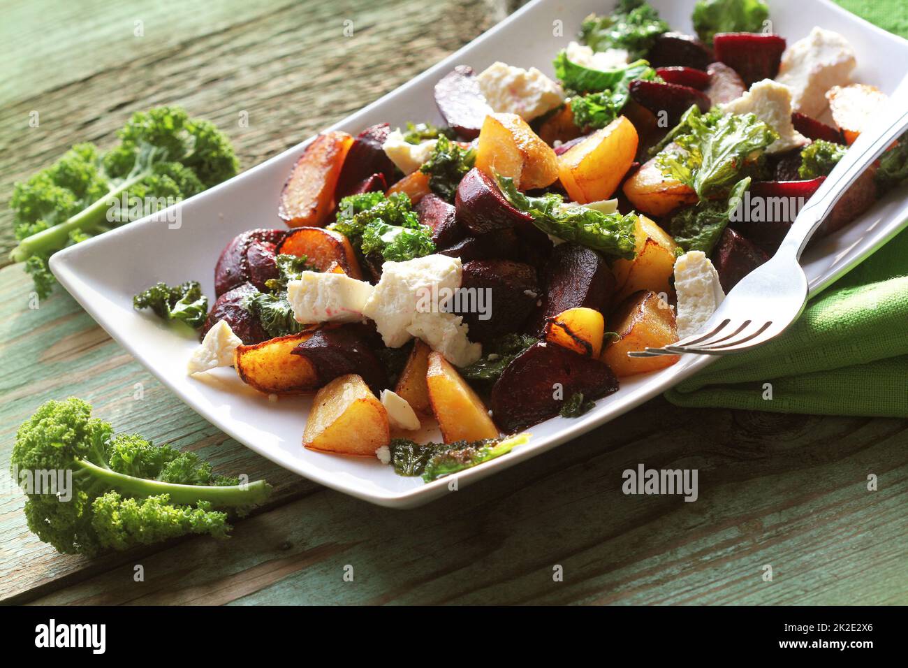 Fresh beet salad with feta cheese and fried cabbage kale Stock Photo ...