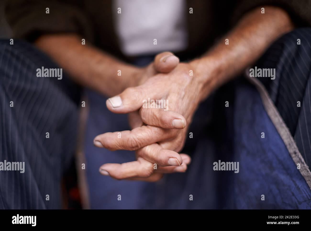 Waiting patiently. Cropped shot of a man sitting with his hands ...