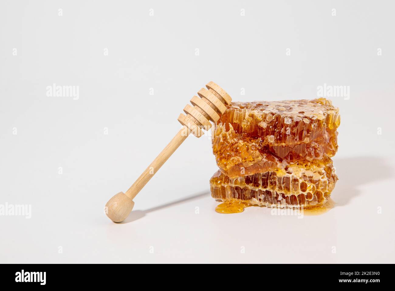 sliced honeycomb and honey dipper stick Stock Photo - Alamy