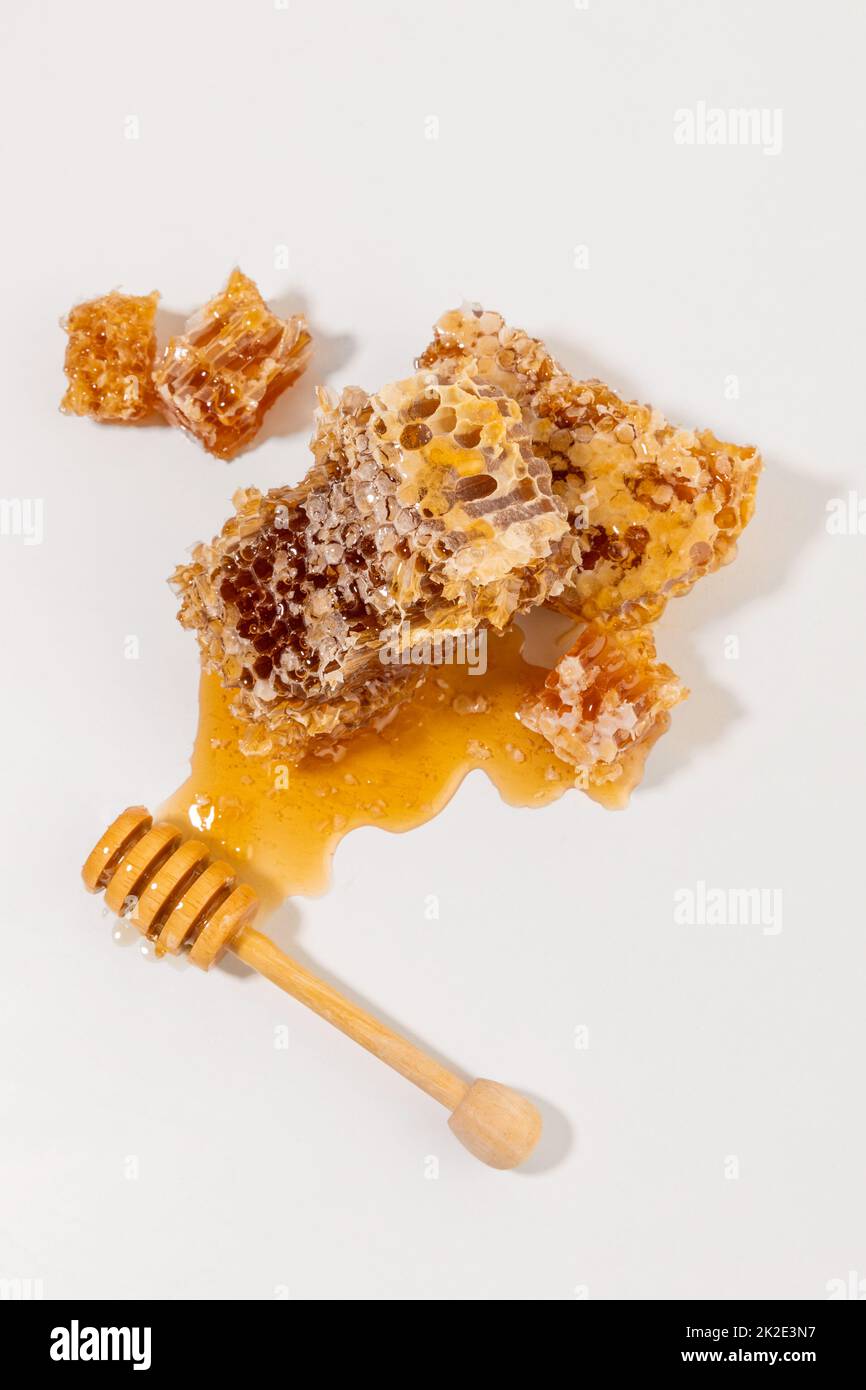 sliced honeycomb and honey dipper stick Stock Photo - Alamy