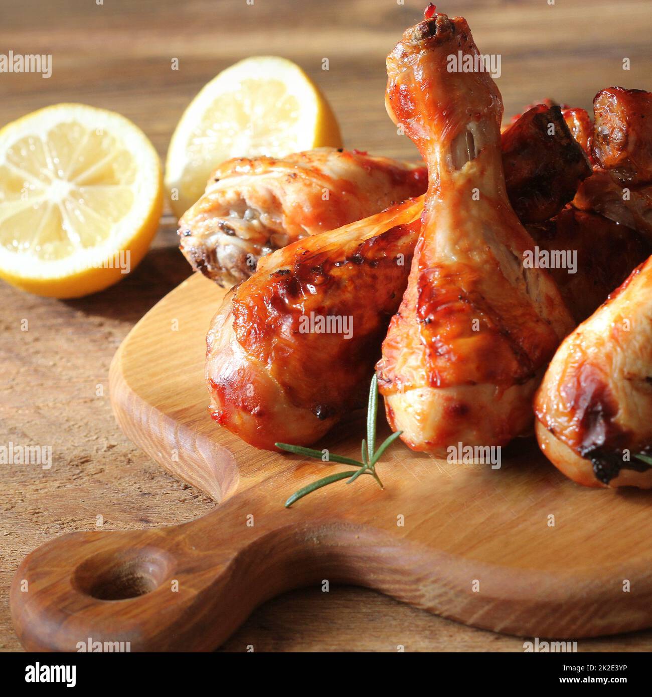 Grilled chicken legs on cutting board. Rustic dinner background Stock ...