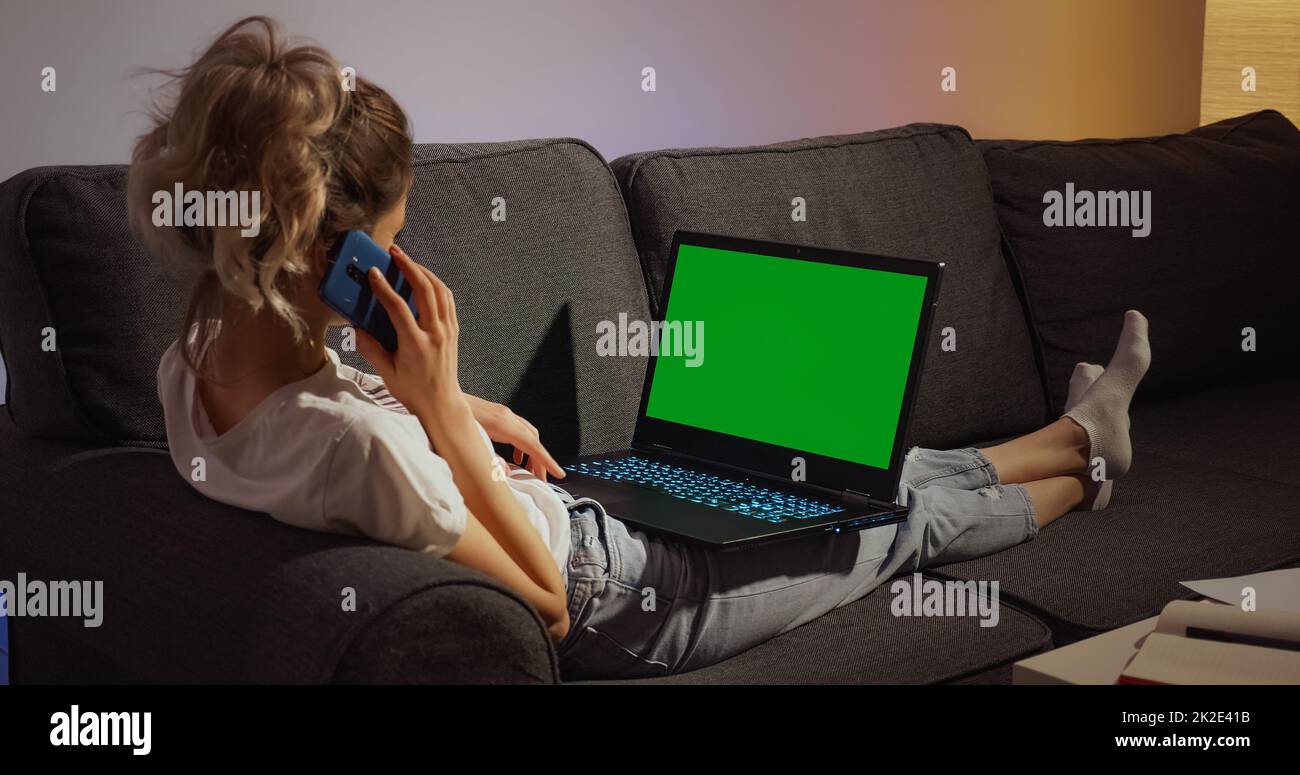 Woman sitting on couch laptop hi-res stock photography and images - Alamy