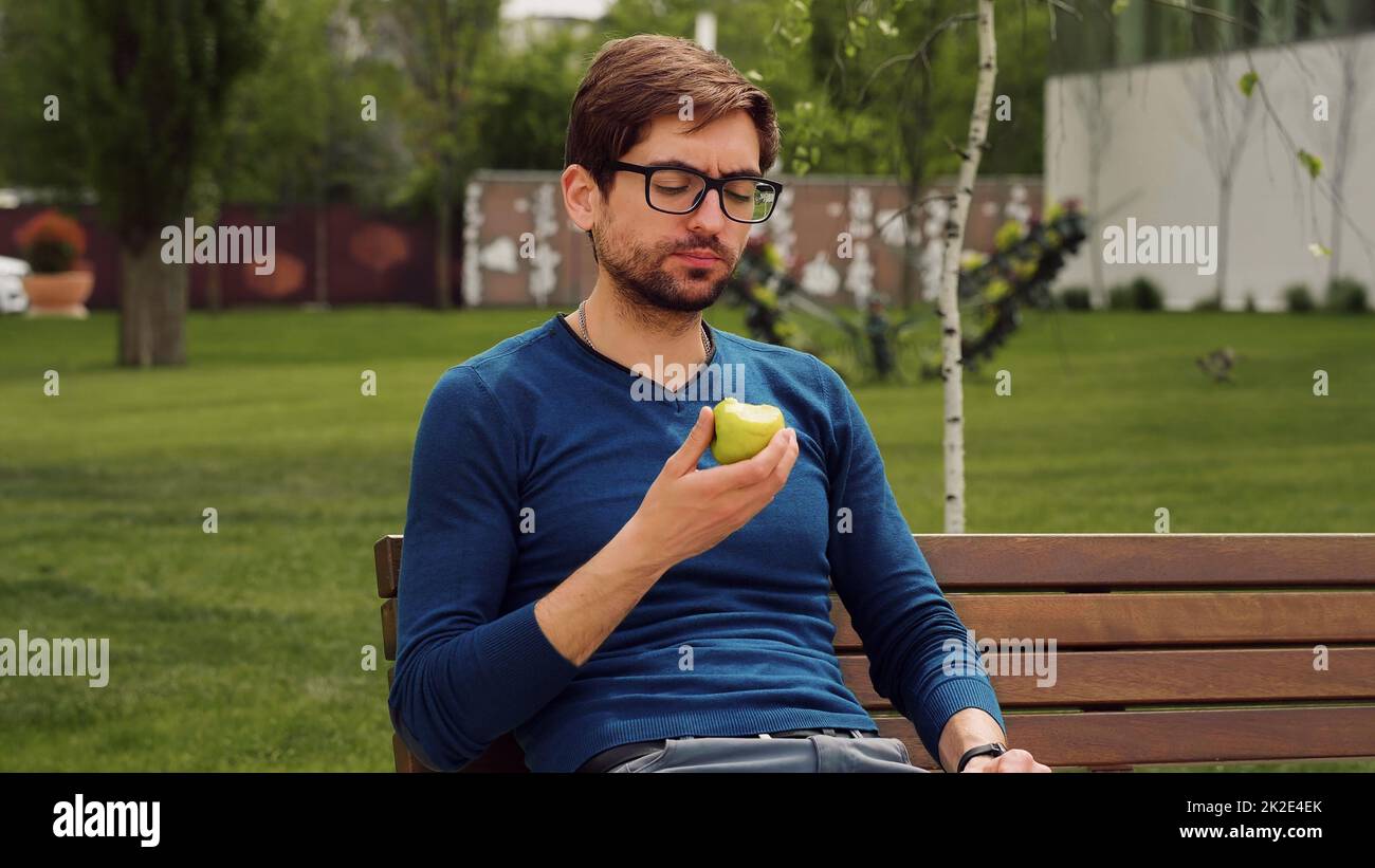 Employee Taking Break Work. Young man Eating a apple as snack. Enjoying ...