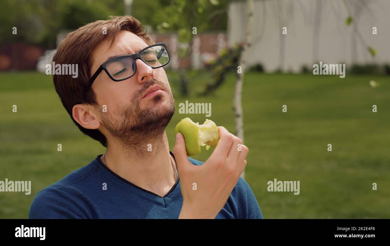 Employee Taking Break Work. Young man Eating a apple as snack. Heathy food Concept Stock Photo ...