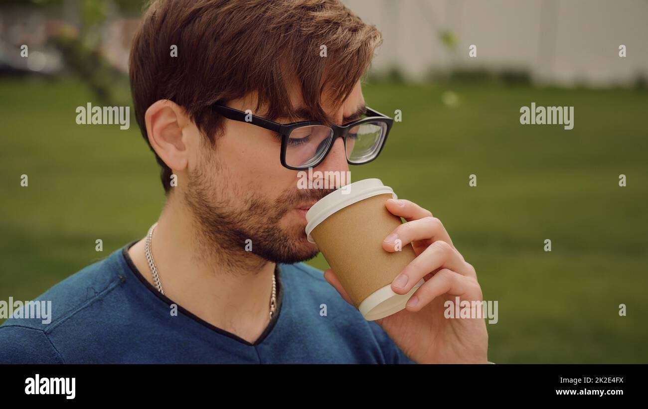Young sad man. Unhappy alone man working outdoor. Closeup face of ...