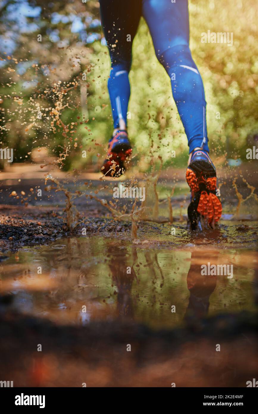 Tearing up the trail. Cropped shot of a mans legs as hes running along ...