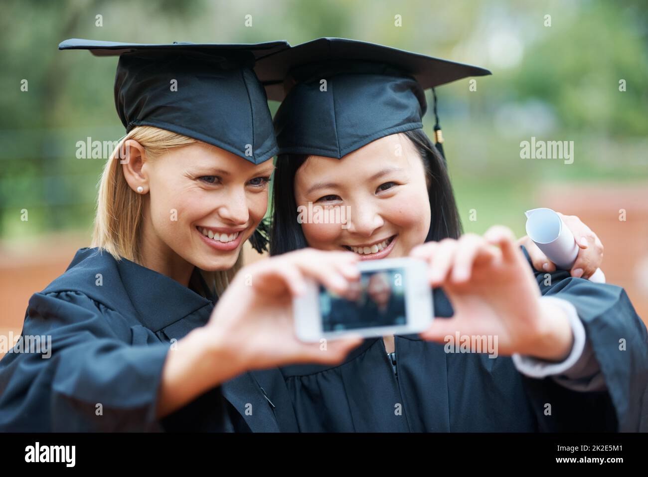 Weve finally graduated. Two young graduates taking a self-portrait at ...