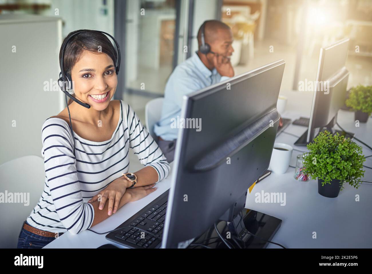 Online and ready to help. Cropped shot of a young attractive female customer support agent ...