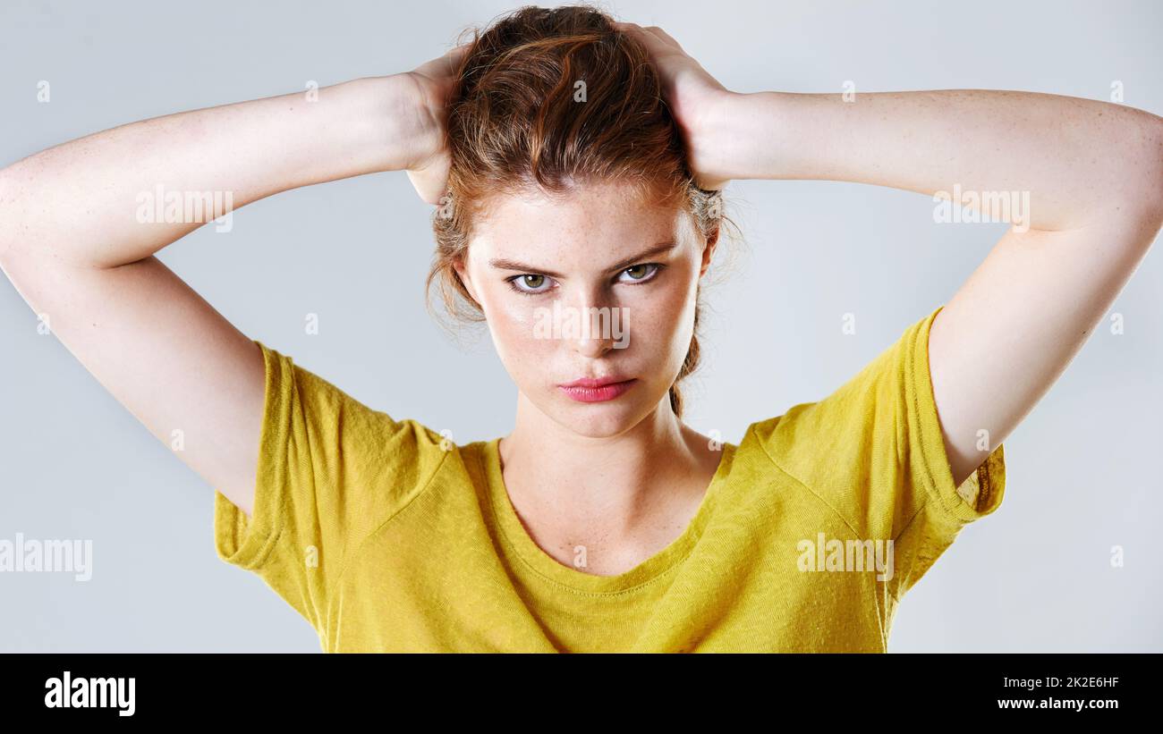 Giving you her best pout. Studio shot of an attractive young woman ...