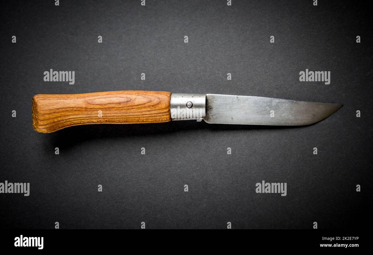Traditional wooden pocket knife on black background Stock Photo - Alamy