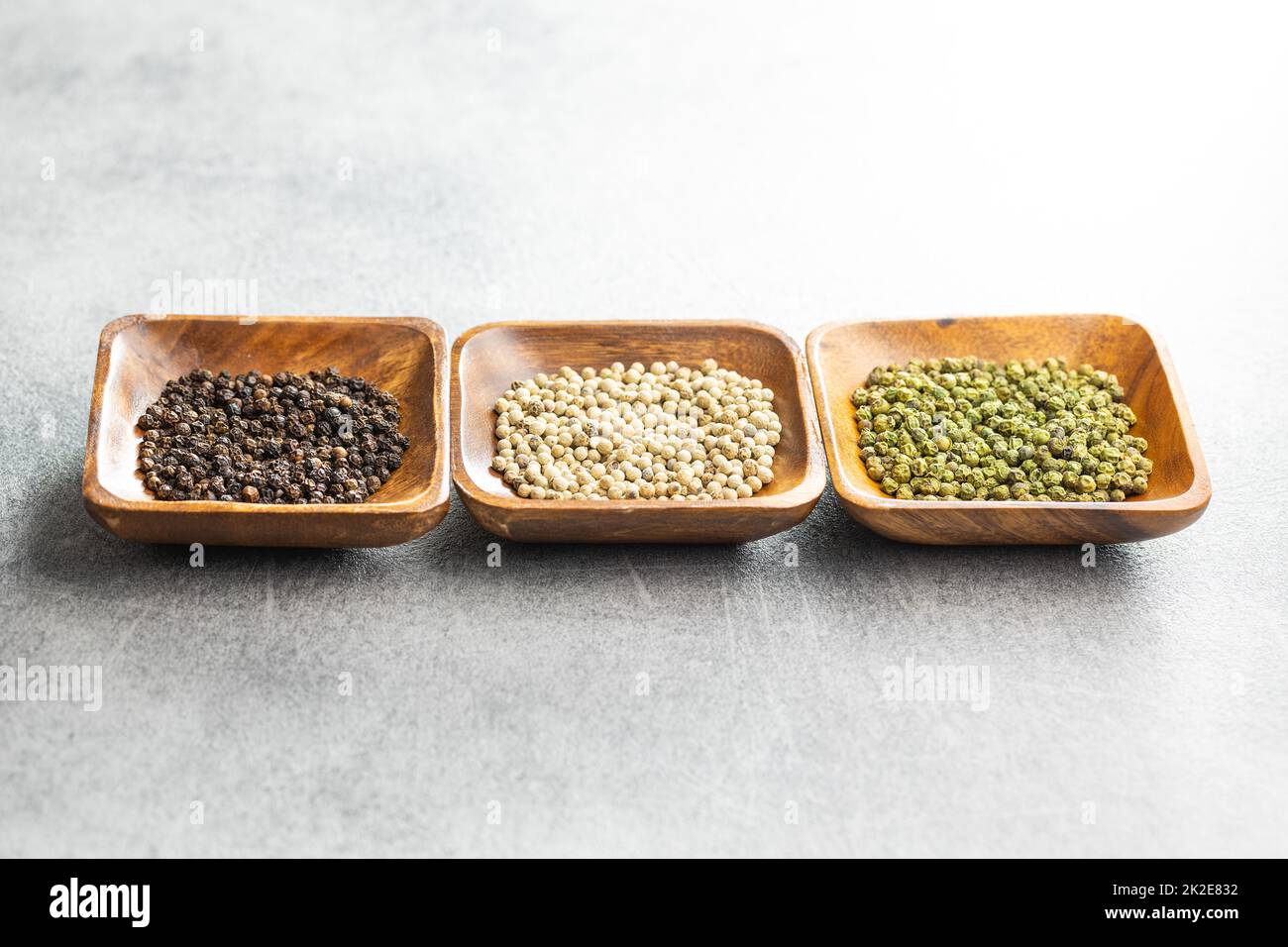 Three different types of pepper spice. Green, white and black ...