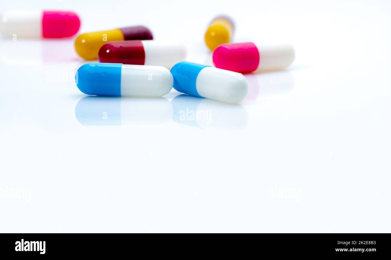 Selective focus on blue-white antibiotic capsule pills on white ...