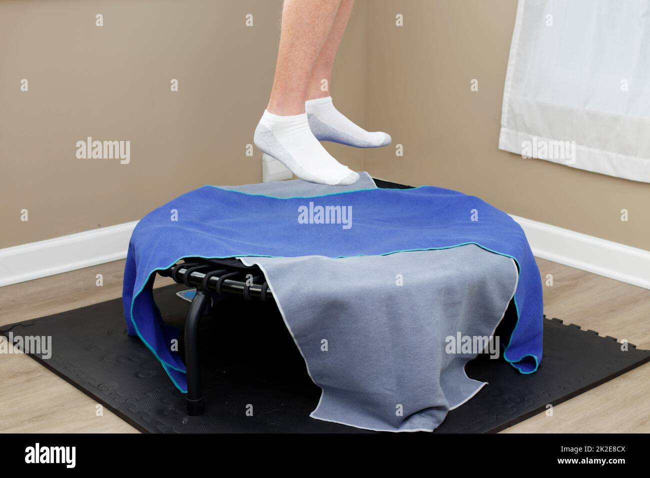 Male Legs Jumped Up in the Air Over a Round Rebounder Close-up Stock ...