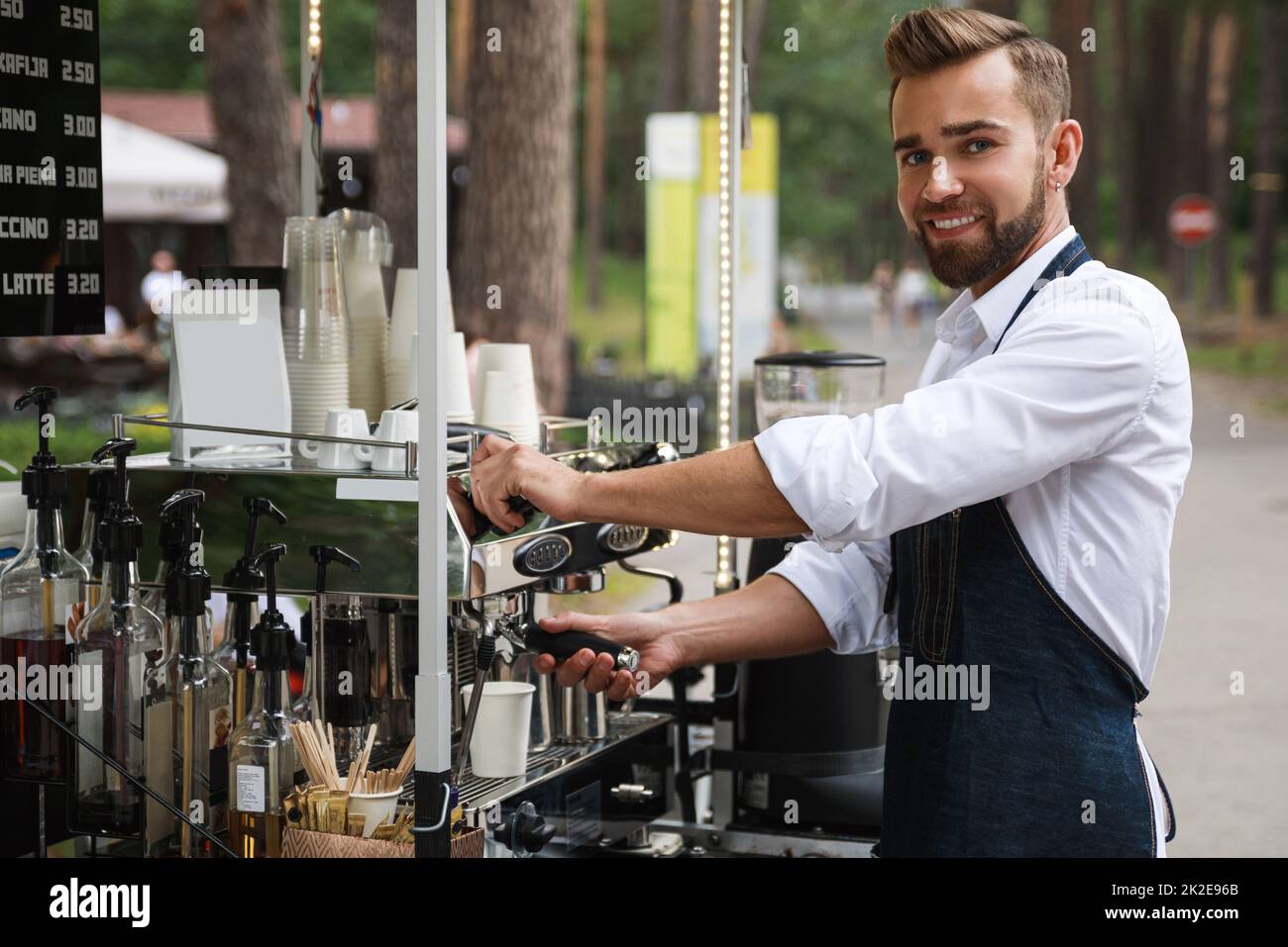 Handsome barista man during work in his street coffee shop Stock Photo ...