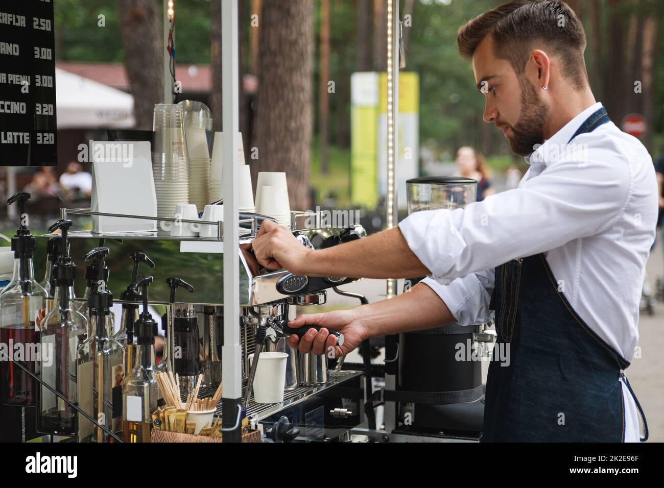 Handsome barista man during work in his street coffee shop Stock Photo ...
