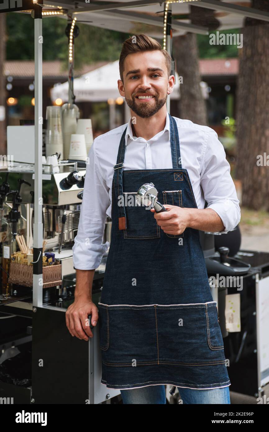 Handsome barista man during work in his street coffee shop Stock Photo ...