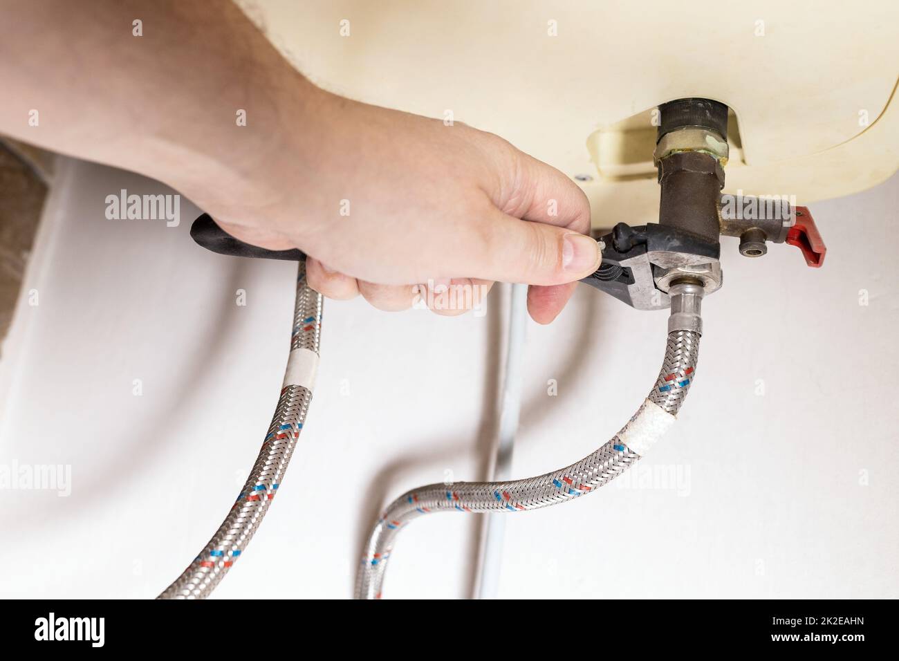 hand installs valve by adjustable wrench on boiler Stock Photo - Alamy