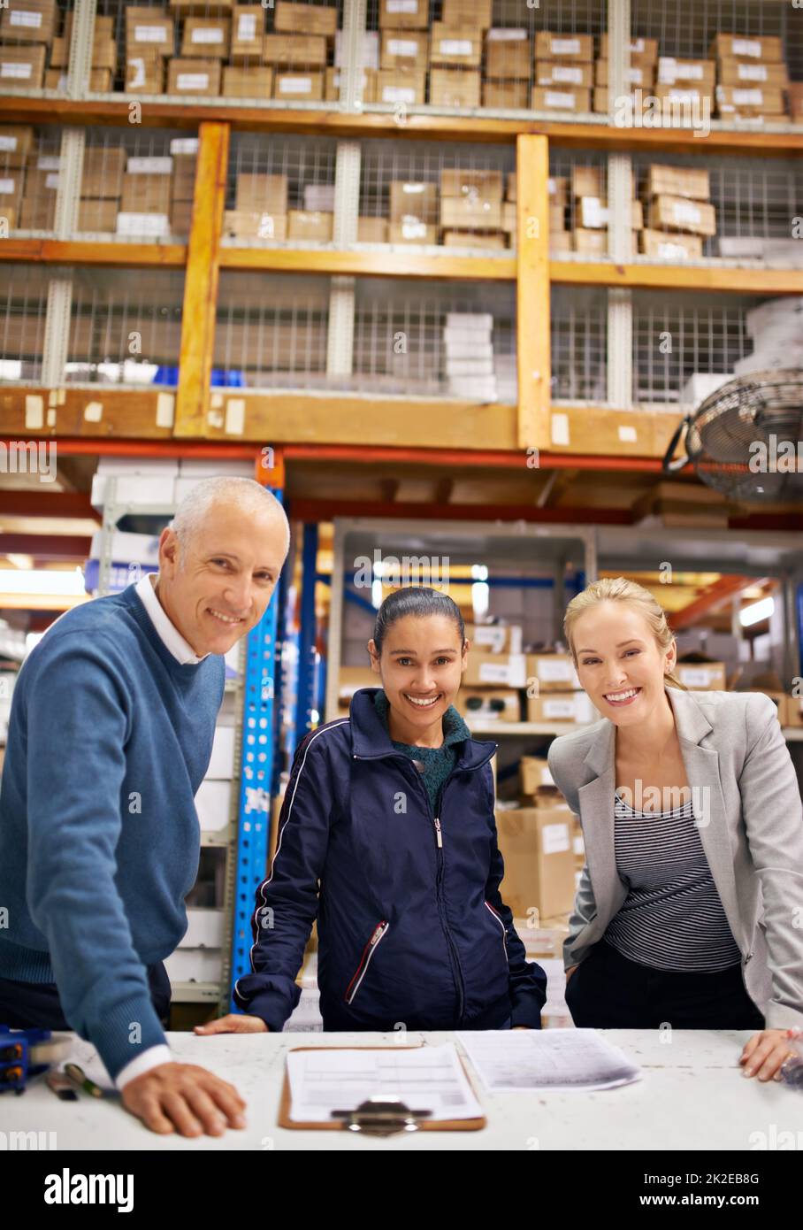 Our stock is flying off the shelves. managers at work supervising a shipping and distribution ...
