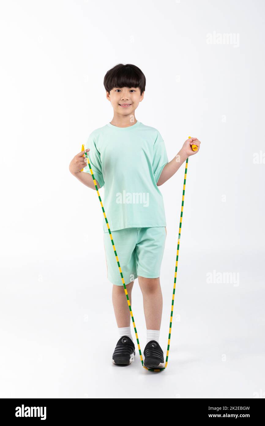 Korean young girl wearing gym clothes in white background studio jump ...