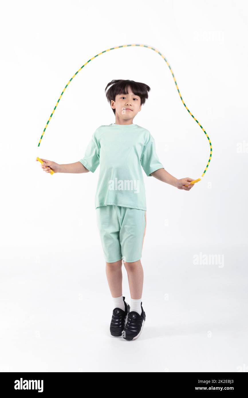 Korean young girl wearing gym clothes in white background studio jump ...