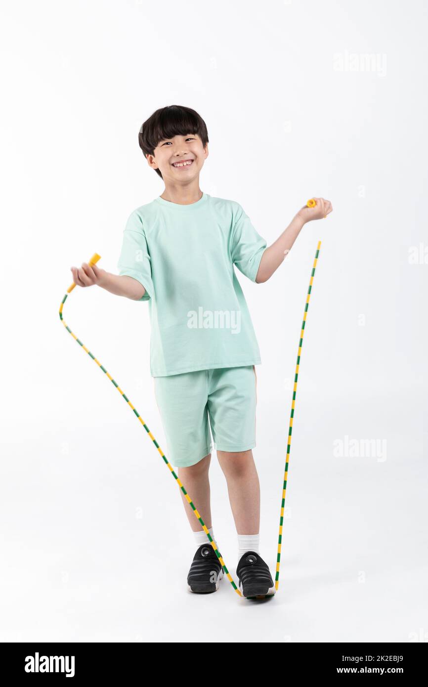 Korean young girl wearing gym clothes in white background studio jump ...