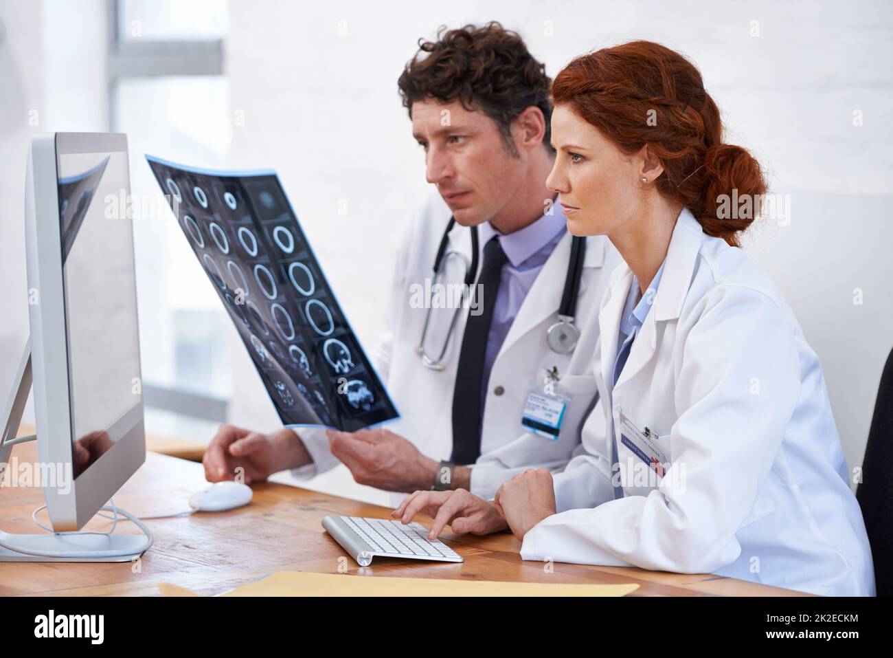 Doctor thinking while typing hi-res stock photography and images - Alamy