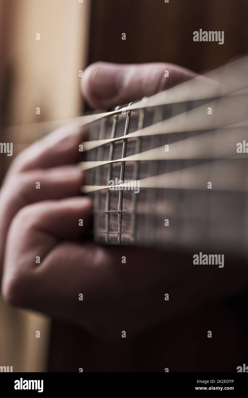 Sweet sounding strings. Cropped shot of an unrecognizable man playing ...