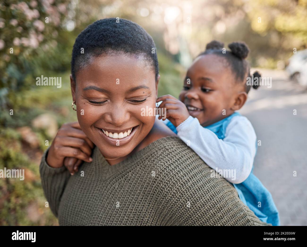 Mother giving daughter a piggyback hi-res stock photography and images ...