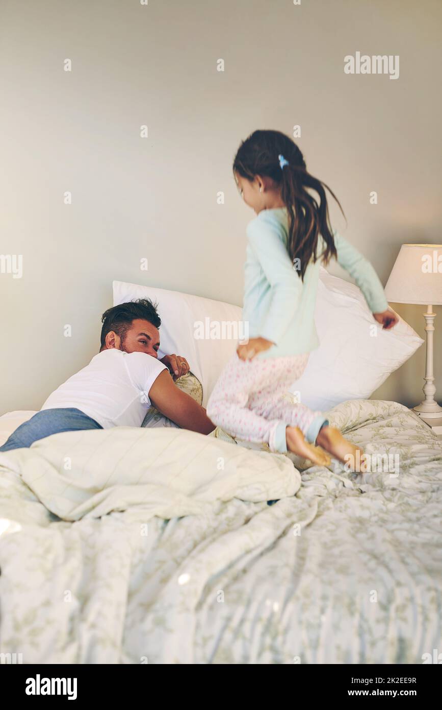 Young family jumping on bed hi-res stock photography and images - Alamy