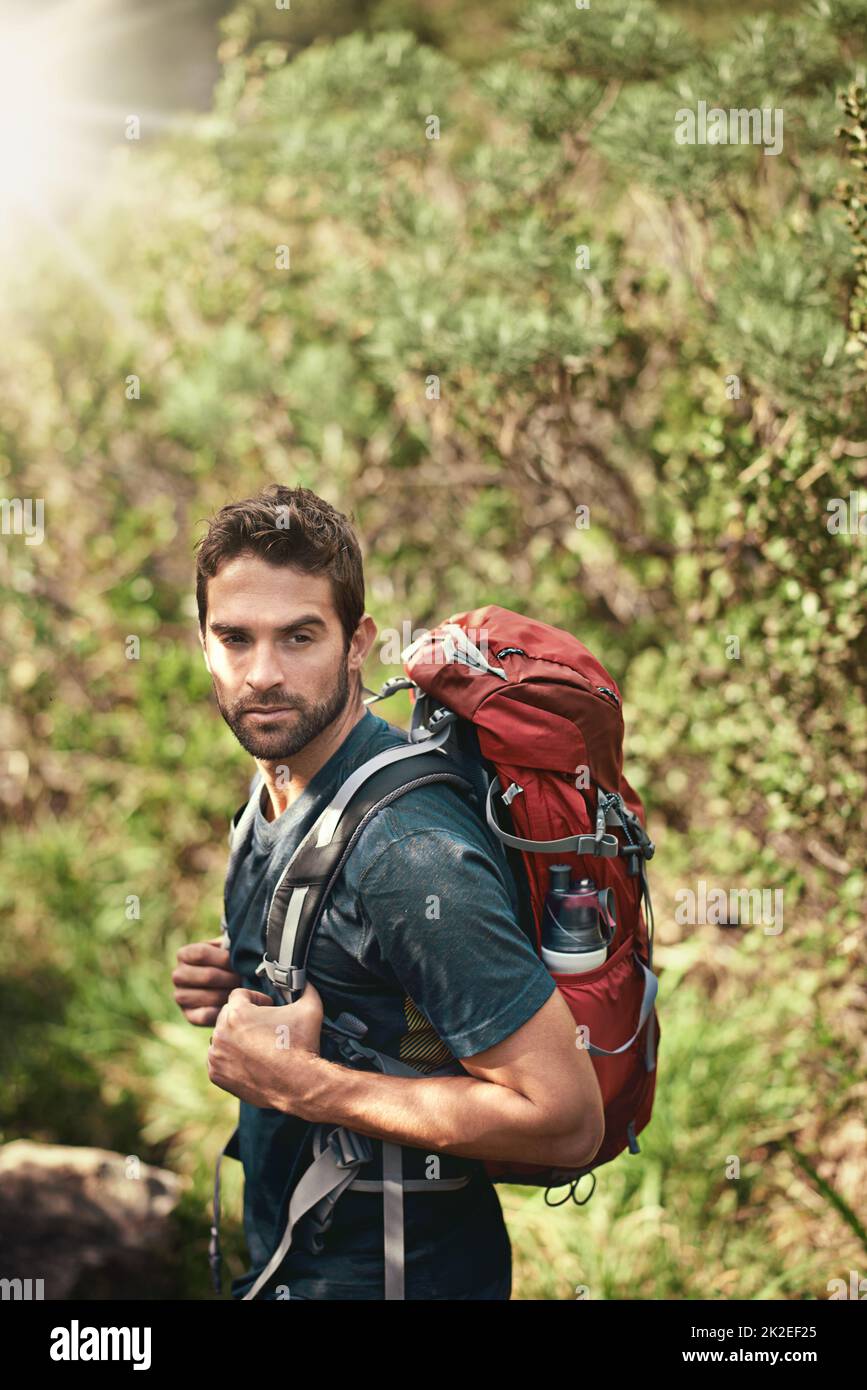 Hes one determined hiker. a young man hiking along a nature trail Stock ...